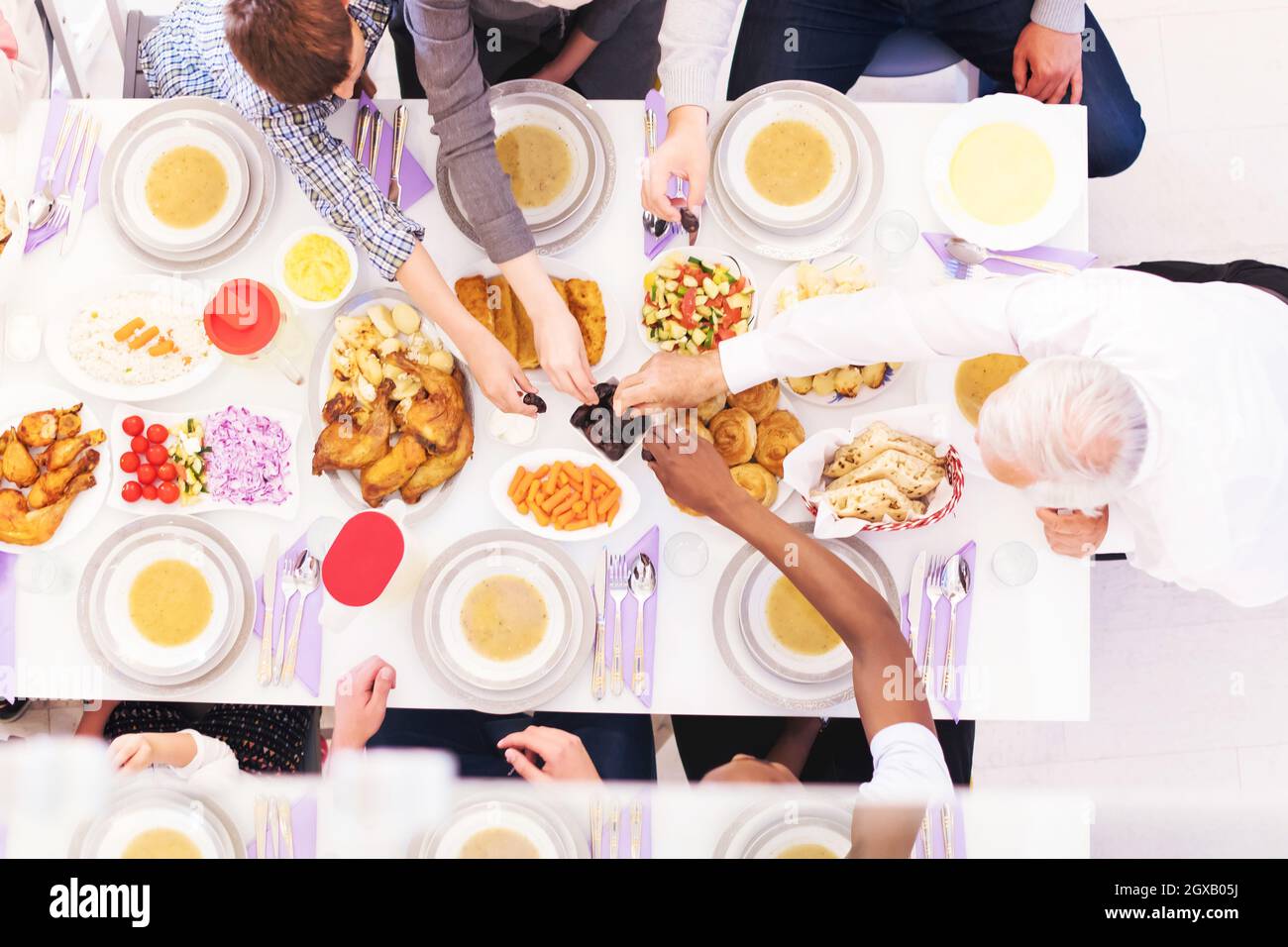 top view of modern multiethnic muslim family enjoying eating iftar ...