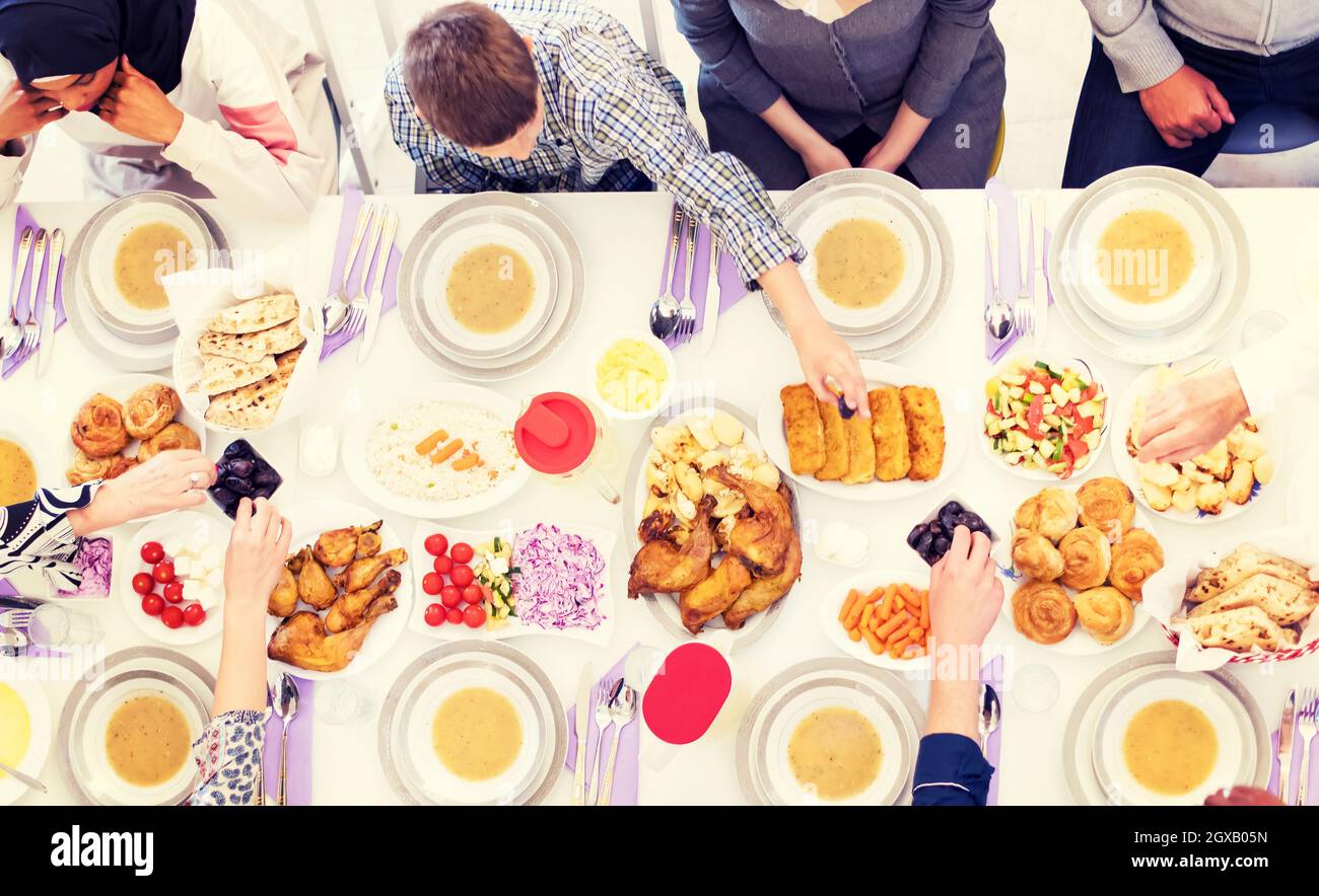 top view of modern multiethnic muslim family enjoying eating iftar ...