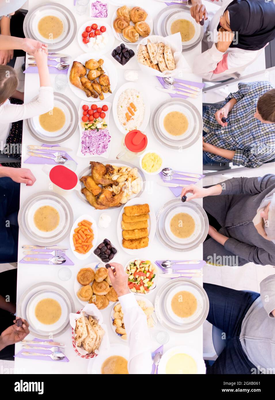 top view of modern multiethnic muslim family enjoying eating iftar ...