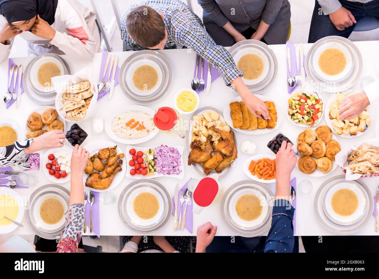 top view of modern multiethnic muslim family enjoying eating iftar ...