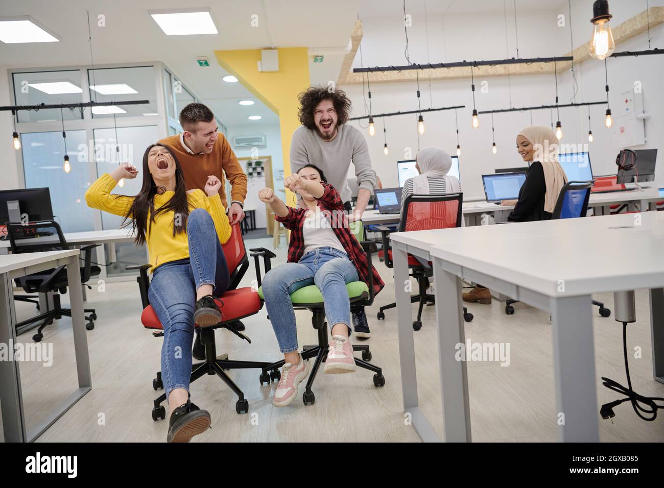 business people having fun while racing on office chairs Stock Photo ...
