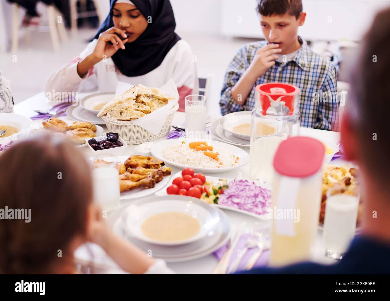 modern multiethnic muslim family enjoying eating iftar dinner together ...