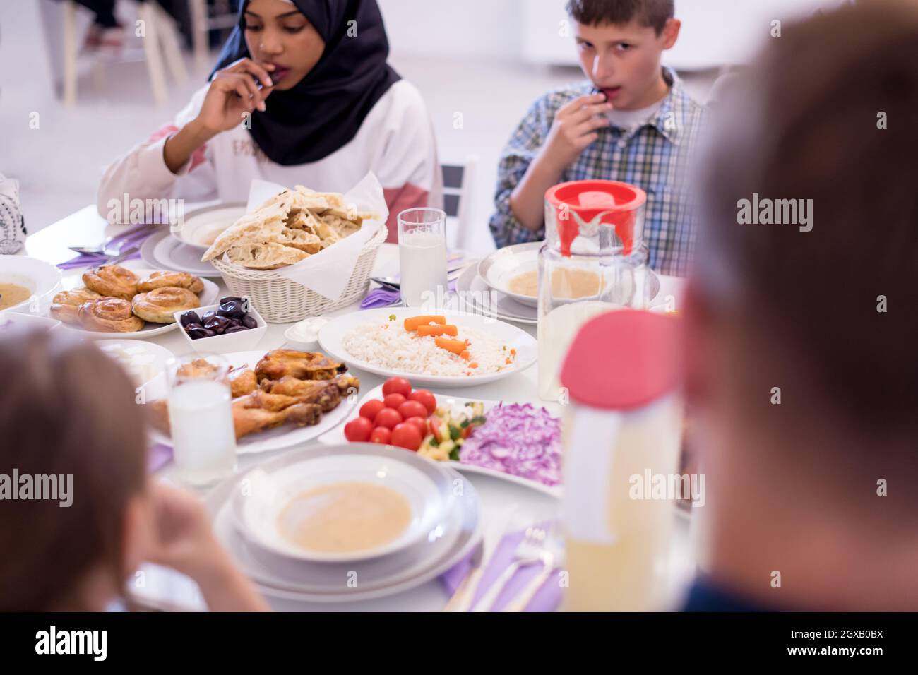 modern multiethnic muslim family enjoying eating iftar dinner together ...