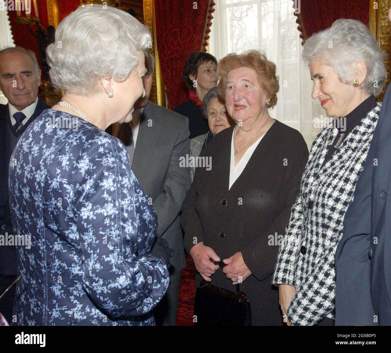 Queen Elizabeth II talks to Eva Clerk (right) during a reception at St ...