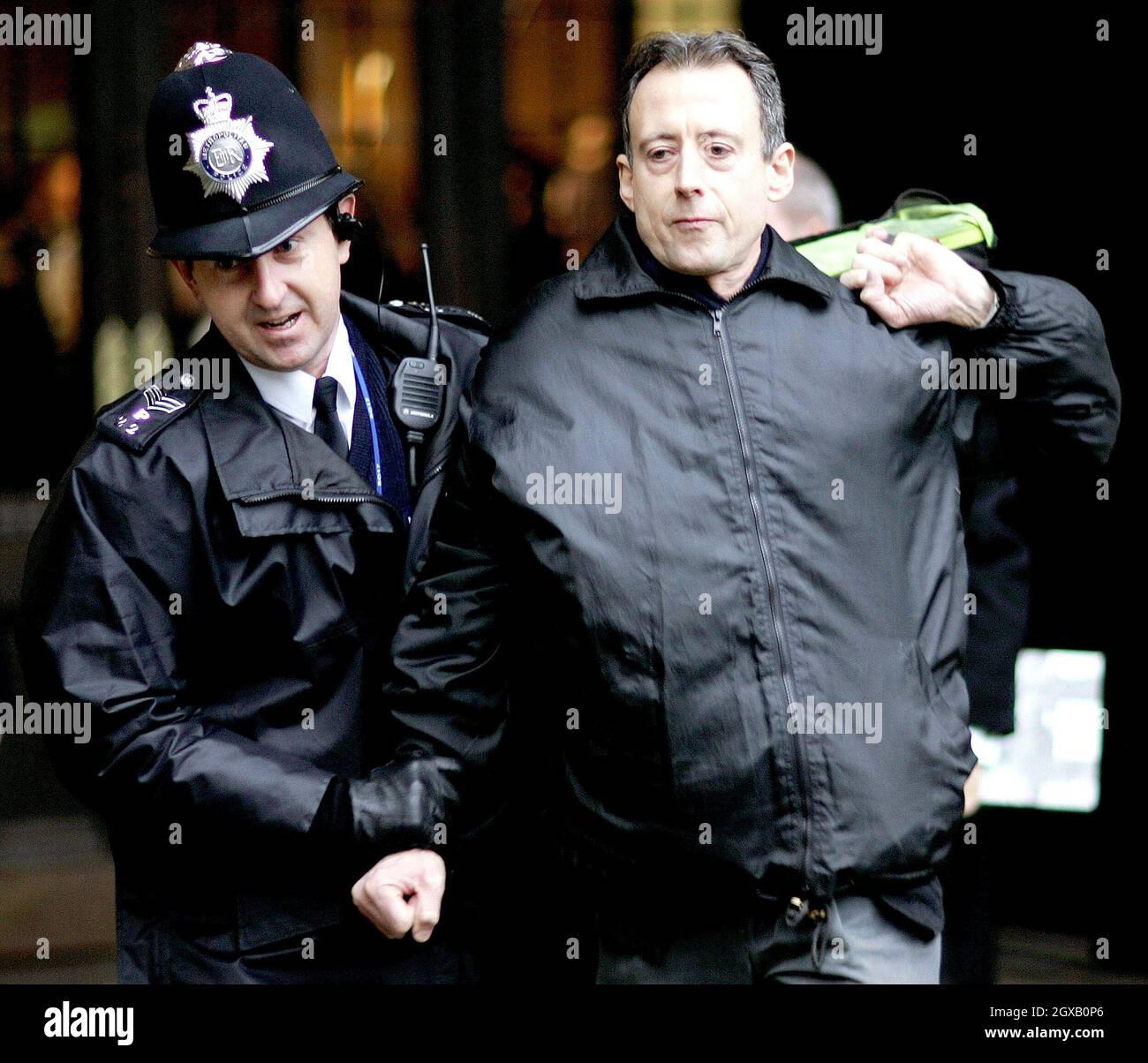 Gay Rights activist Peter Tatchell (R) is escorted by a policeman from ...