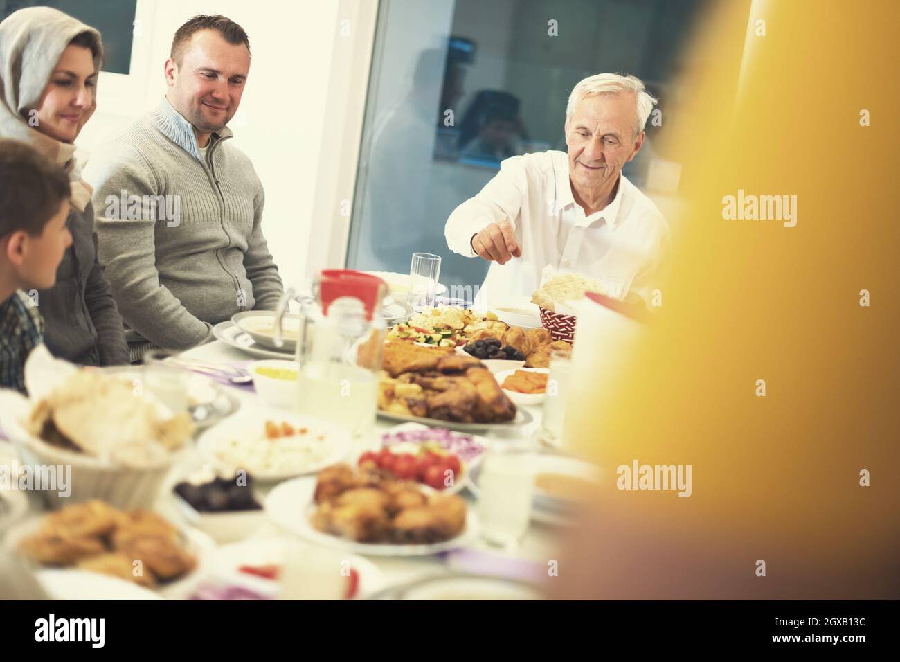 modern multiethnic muslim family enjoying eating iftar dinner together ...
