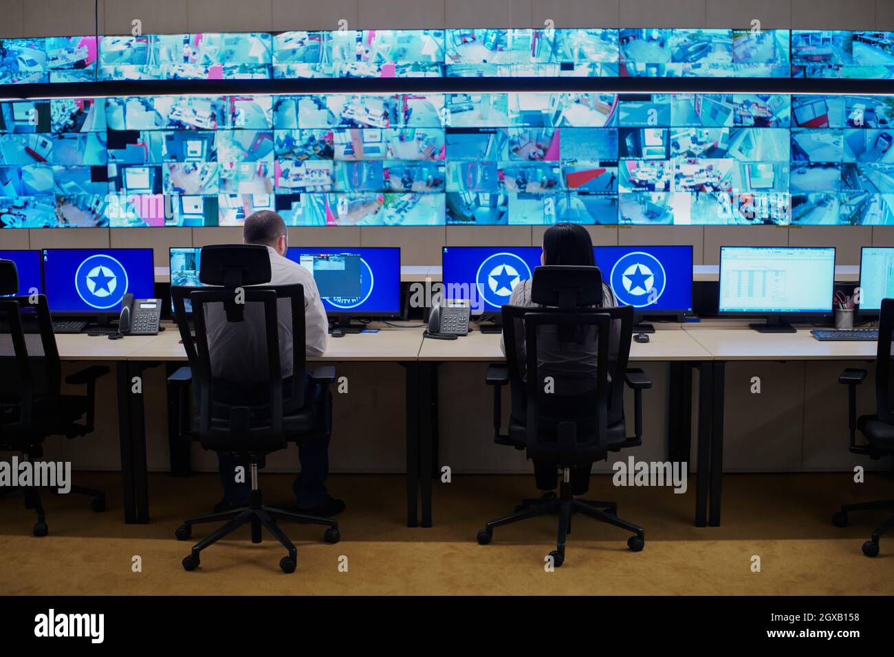Group of Security data center operators working in a CCTV monitoring ...