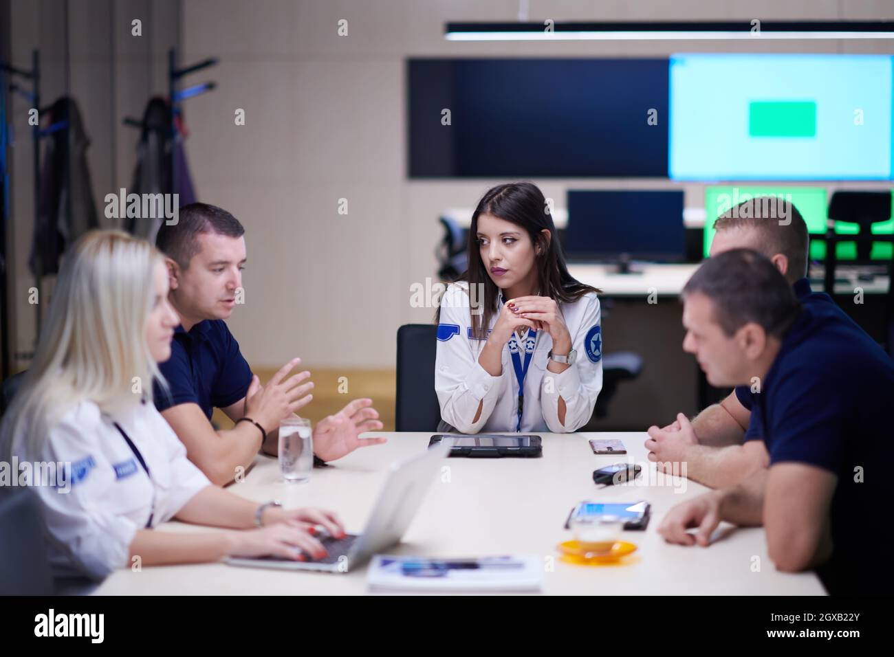 Group of security guards sitting and having briefing In the system ...