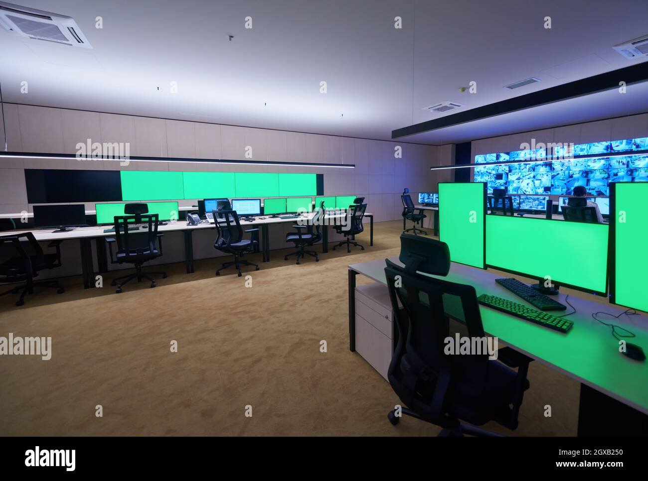 Empty interior of big modern security system control room with blank ...
