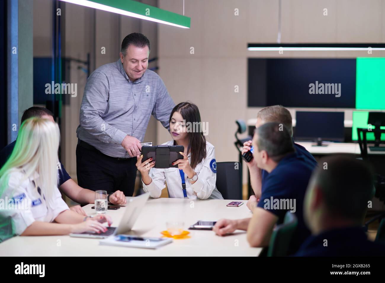 Group of security guards sitting and having briefing In the system ...