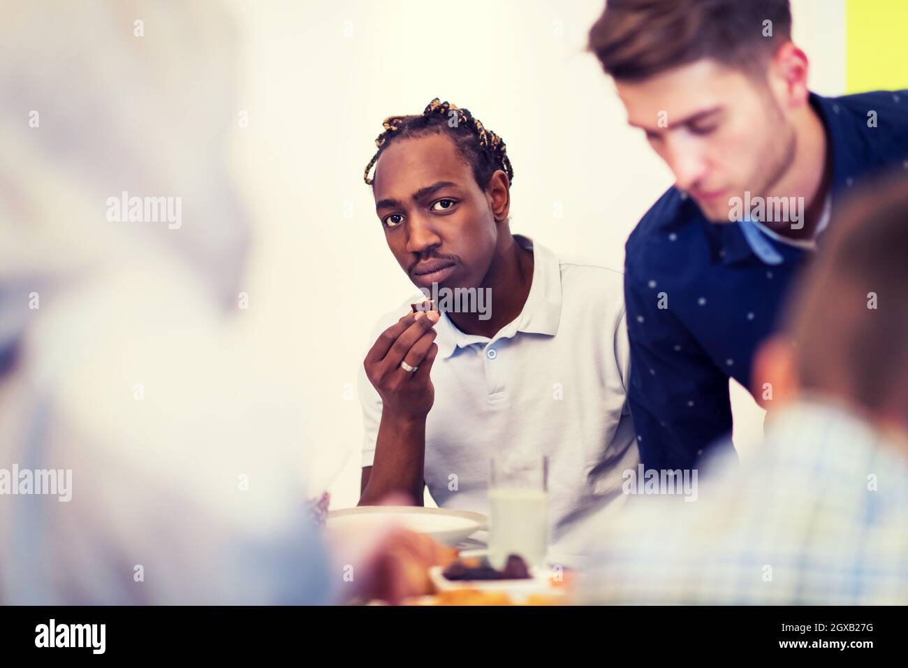 african american man enjoying iftar dinner together with modern ...