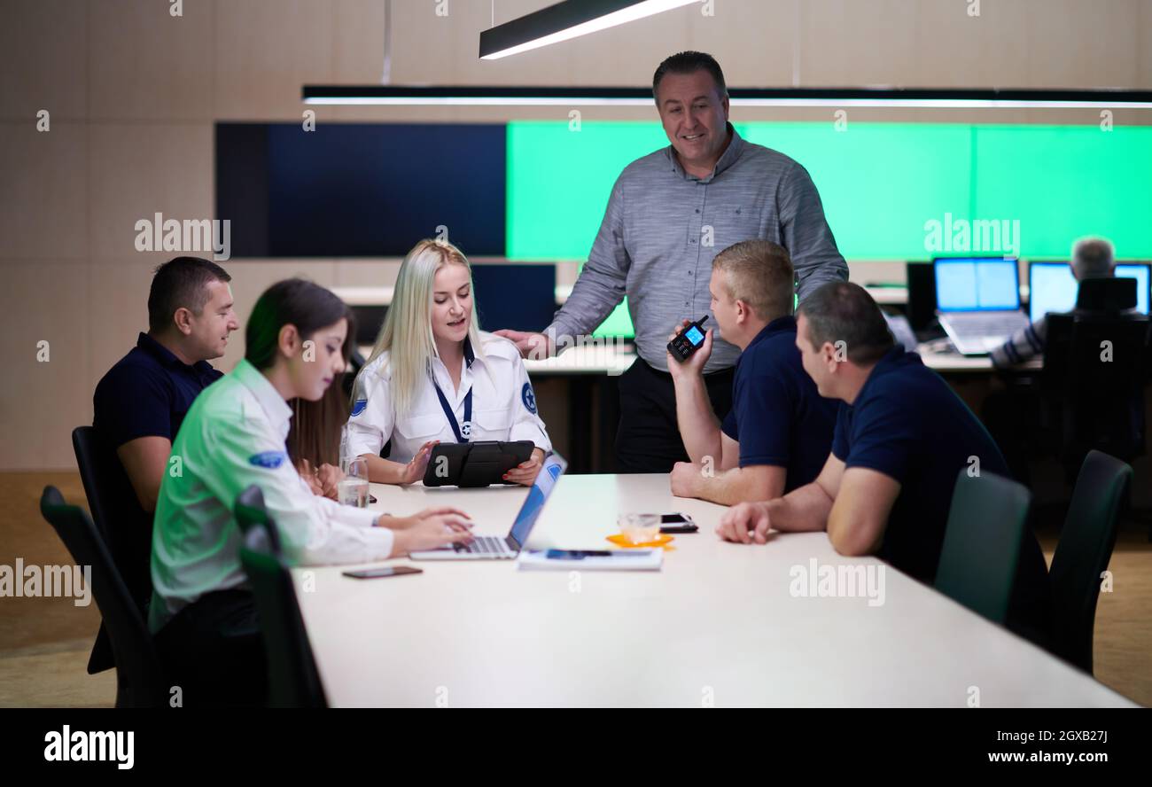 Group of security guards sitting and having briefing In the system ...