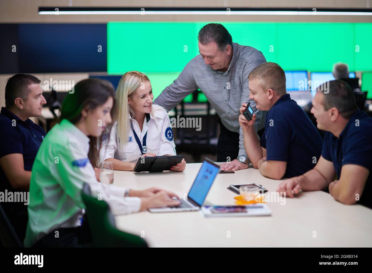 Group of security guards sitting and having briefing In the system ...