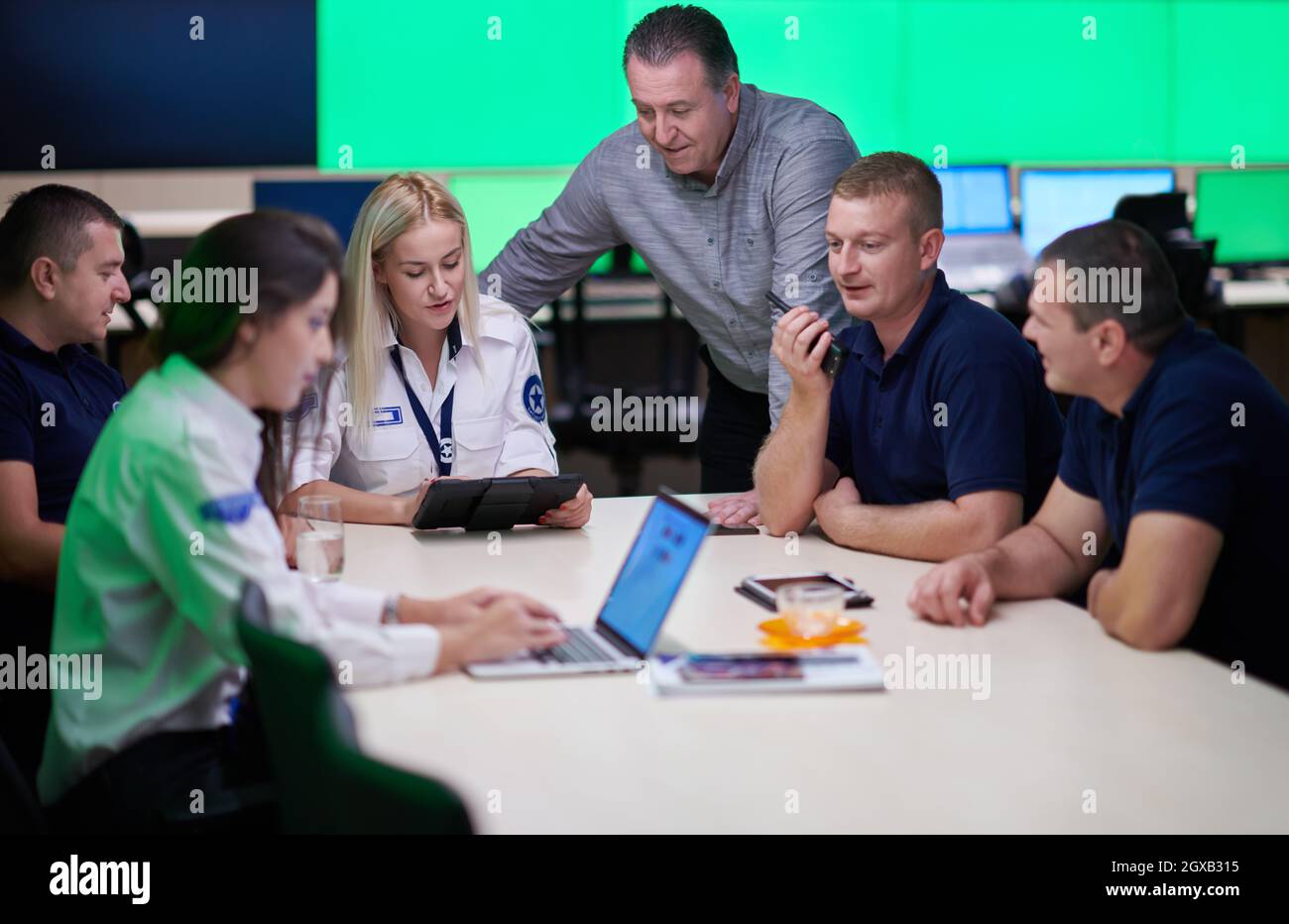 Group of security guards sitting and having briefing In the system ...