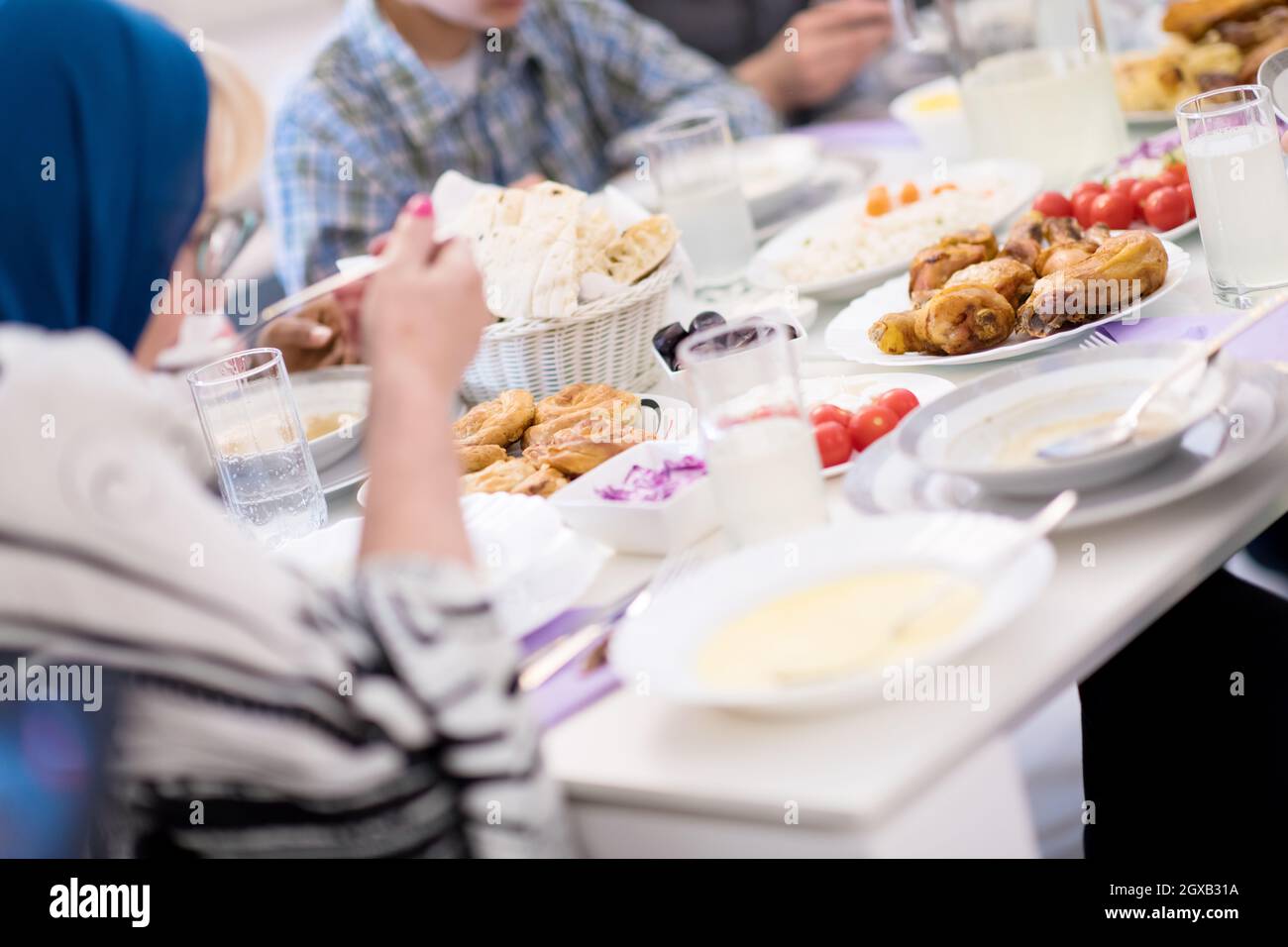 modern multiethnic muslim family enjoying eating iftar dinner together ...