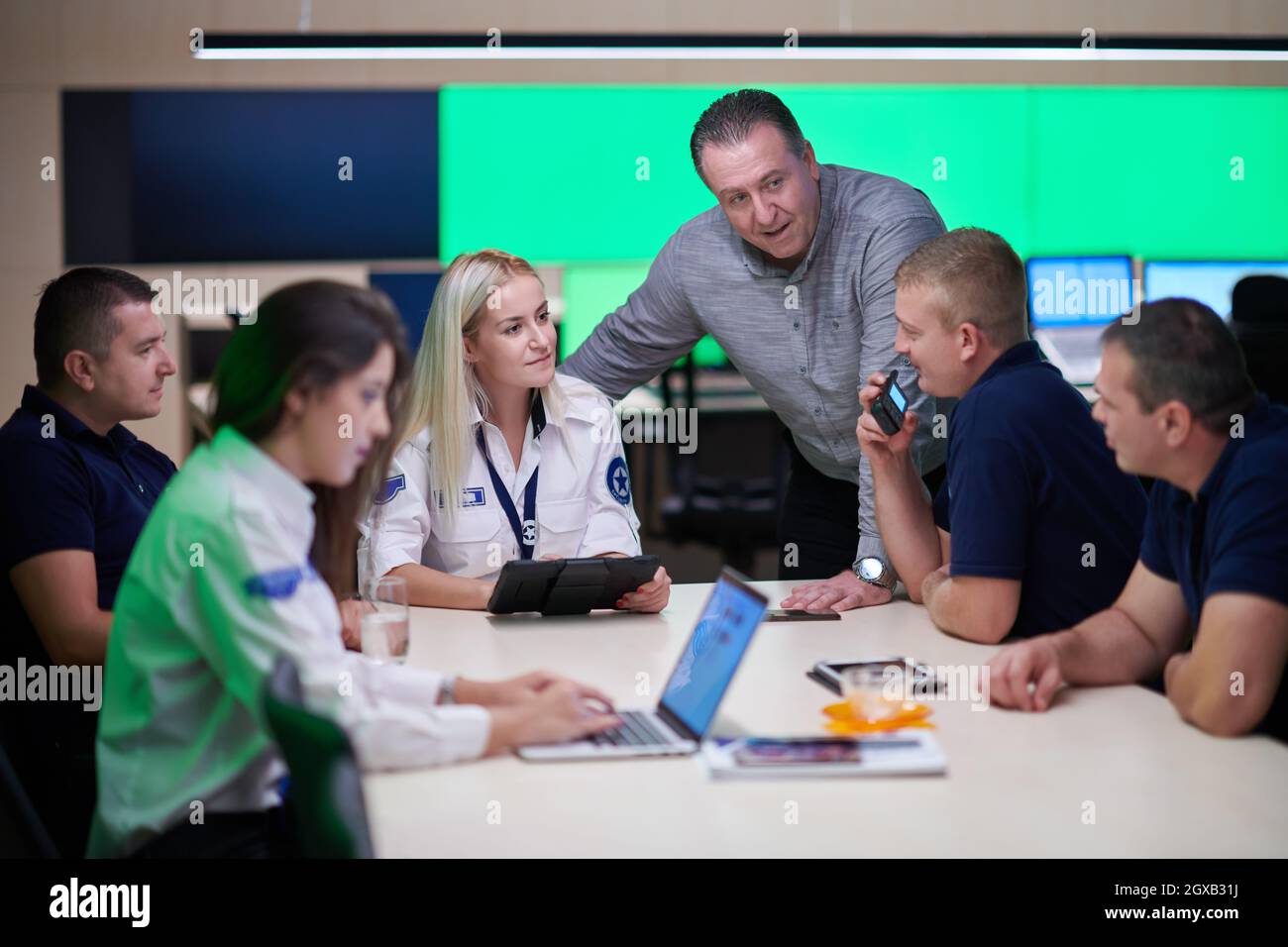 Group of security guards sitting and having briefing In the system ...
