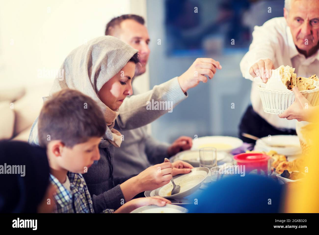 modern multiethnic muslim family enjoying eating iftar dinner together ...