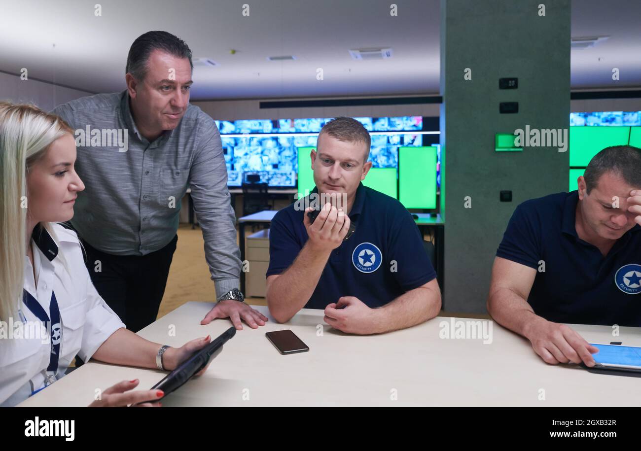 Group of security guards sitting and having briefing In the system ...