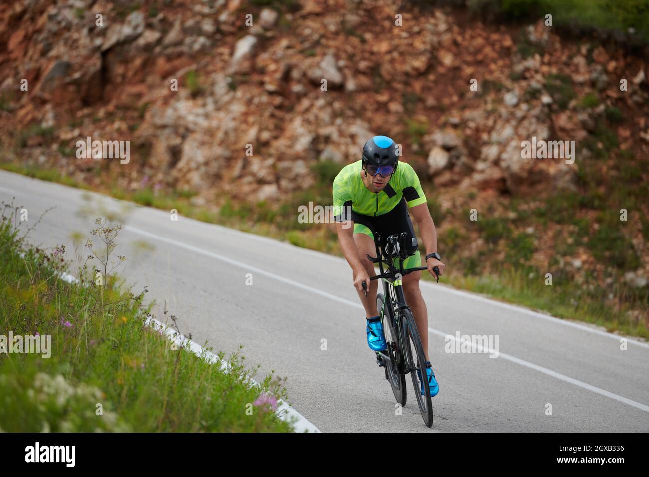 triathlon athlete riding professional racing bike at workout on curvy country road Stock Photo ...