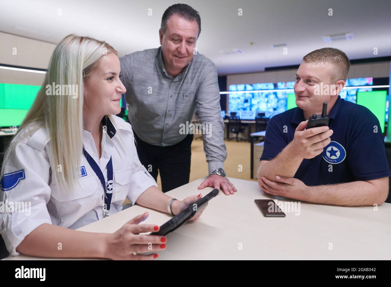 Group of security guards sitting and having briefing In the system ...