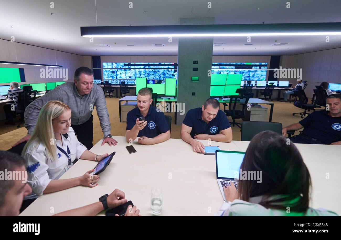 Group of security guards sitting and having briefing In the system ...