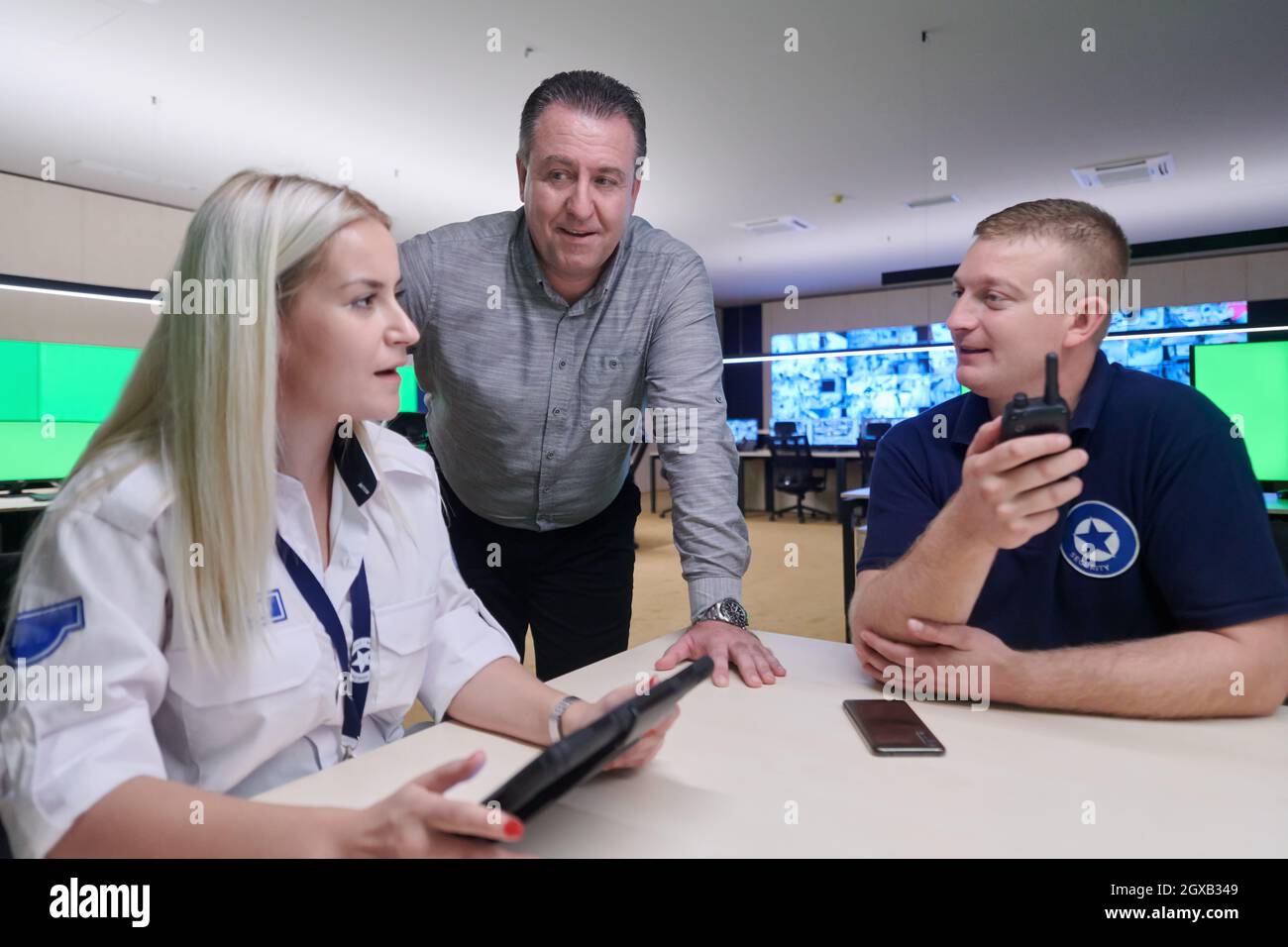 Group of security guards sitting and having briefing In the system ...