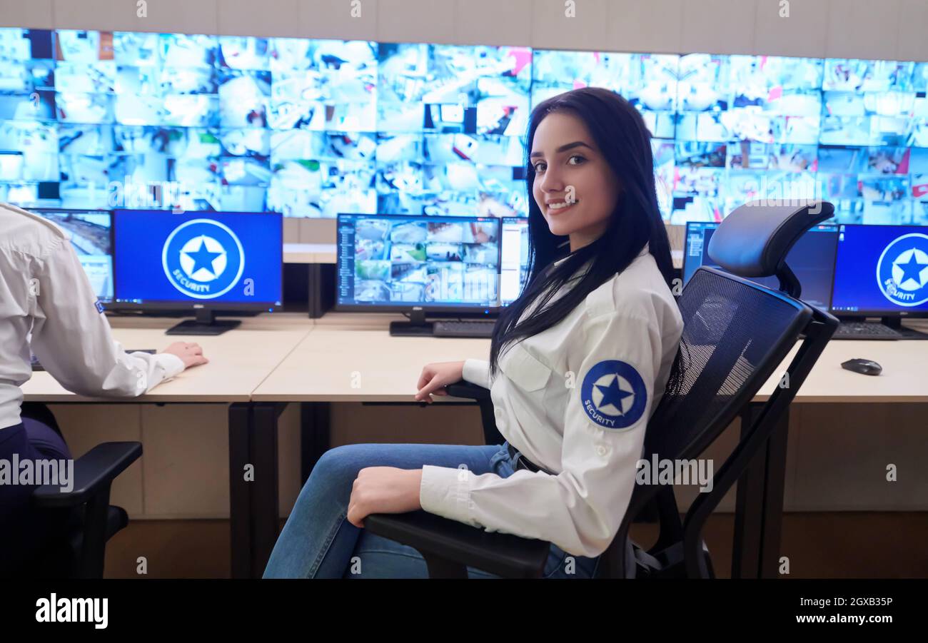 Portrait Of Female Security Operator While Working In A Data System Control Room Offices