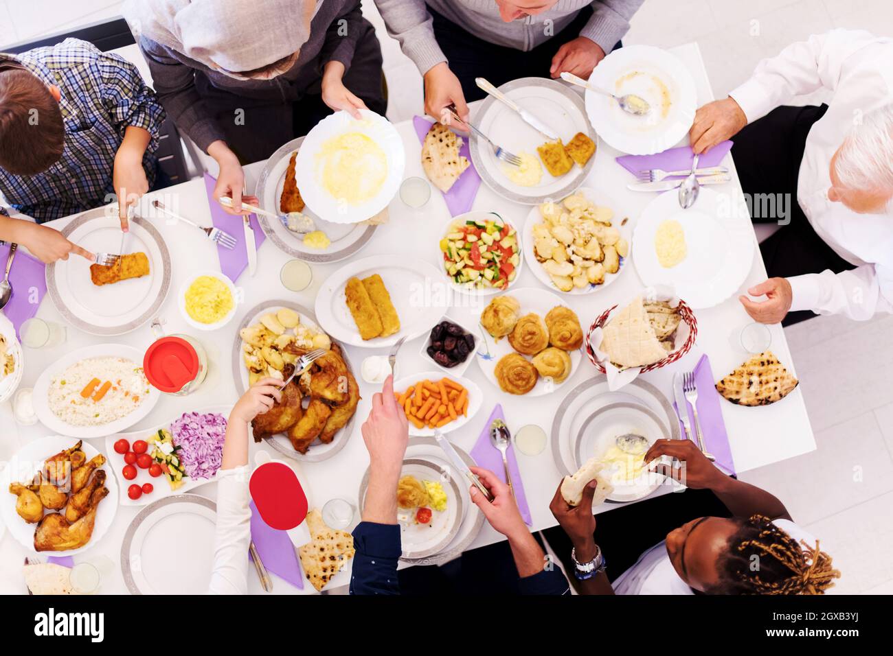 top view of modern multiethnic muslim family enjoying eating iftar ...