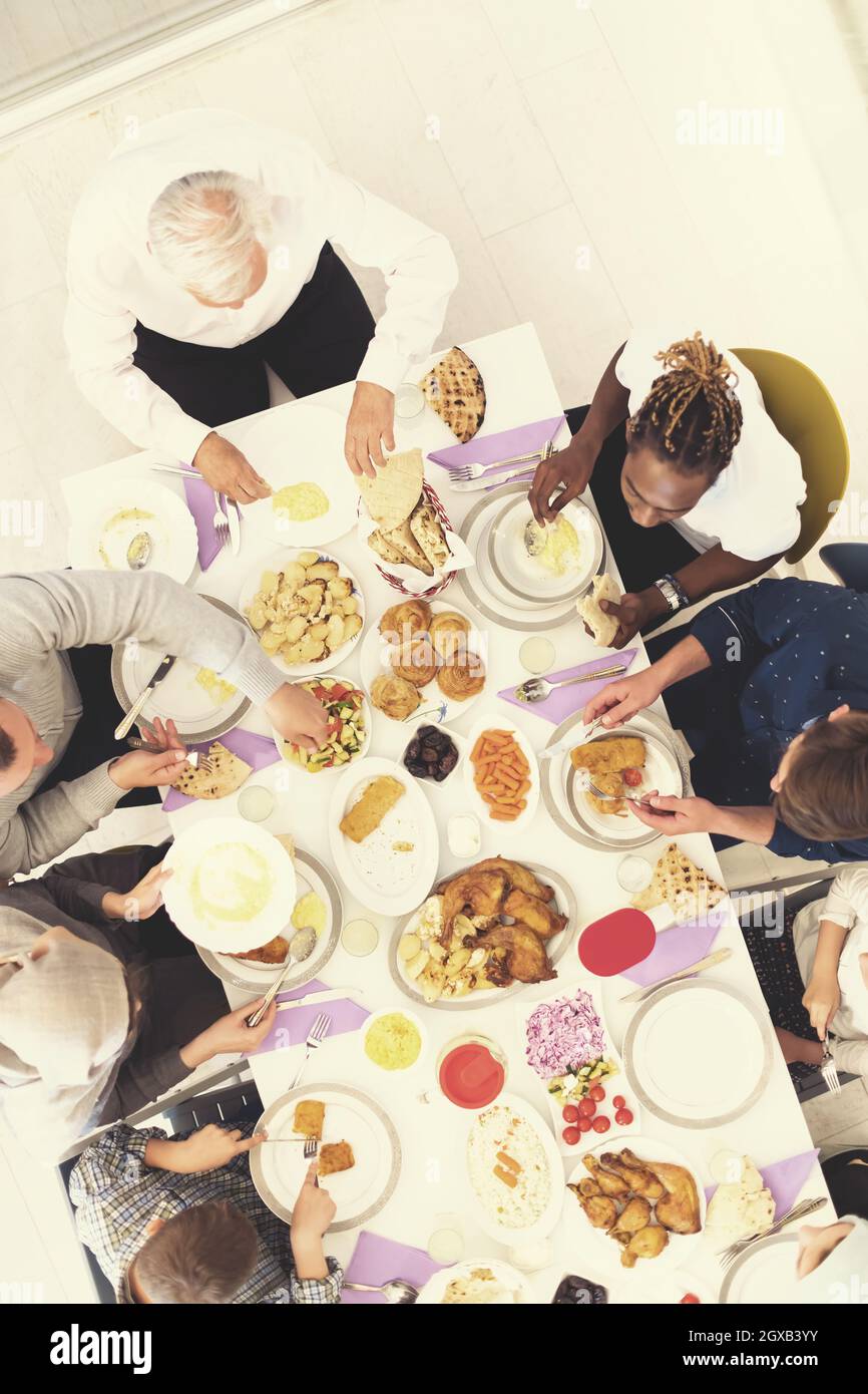 top view of modern multiethnic muslim family enjoying eating iftar ...
