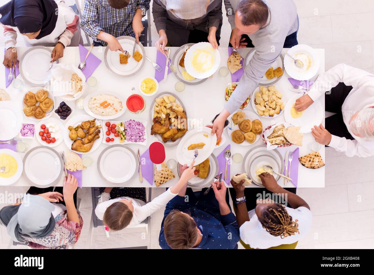 top view of modern multiethnic muslim family enjoying eating iftar ...