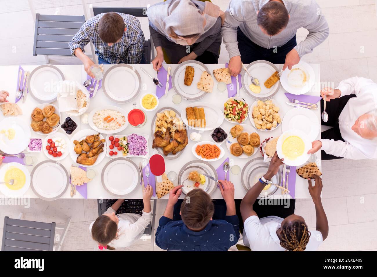 top view of modern multiethnic muslim family enjoying eating iftar ...