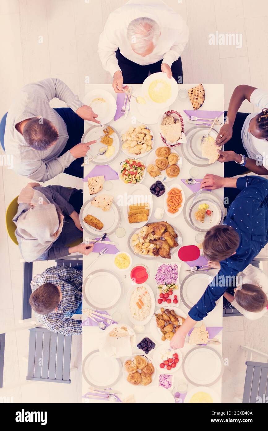 top view of modern multiethnic muslim family enjoying eating iftar ...