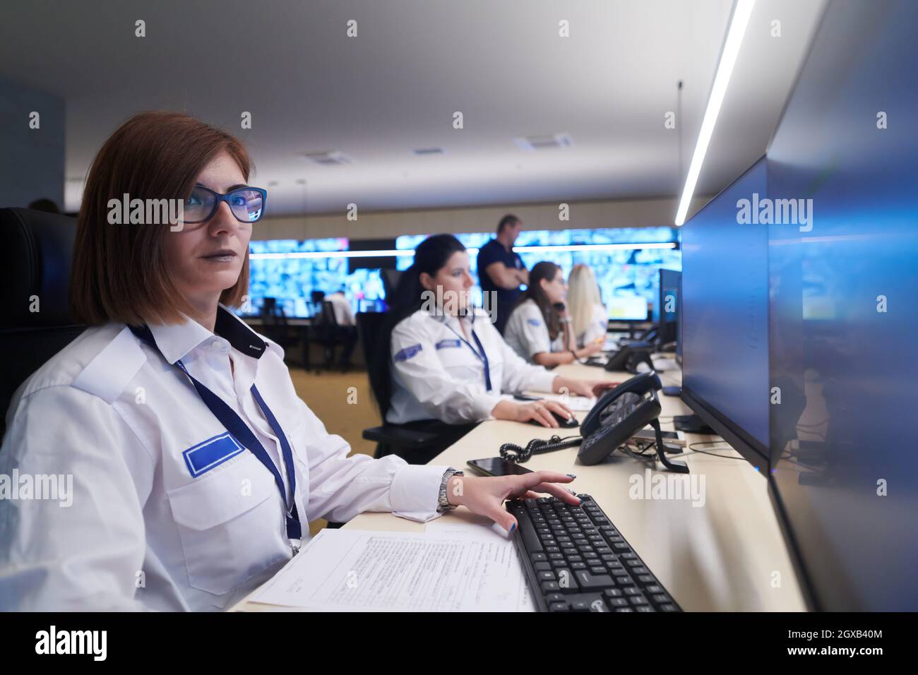 Group of Security data center operators working in a CCTV monitoring ...