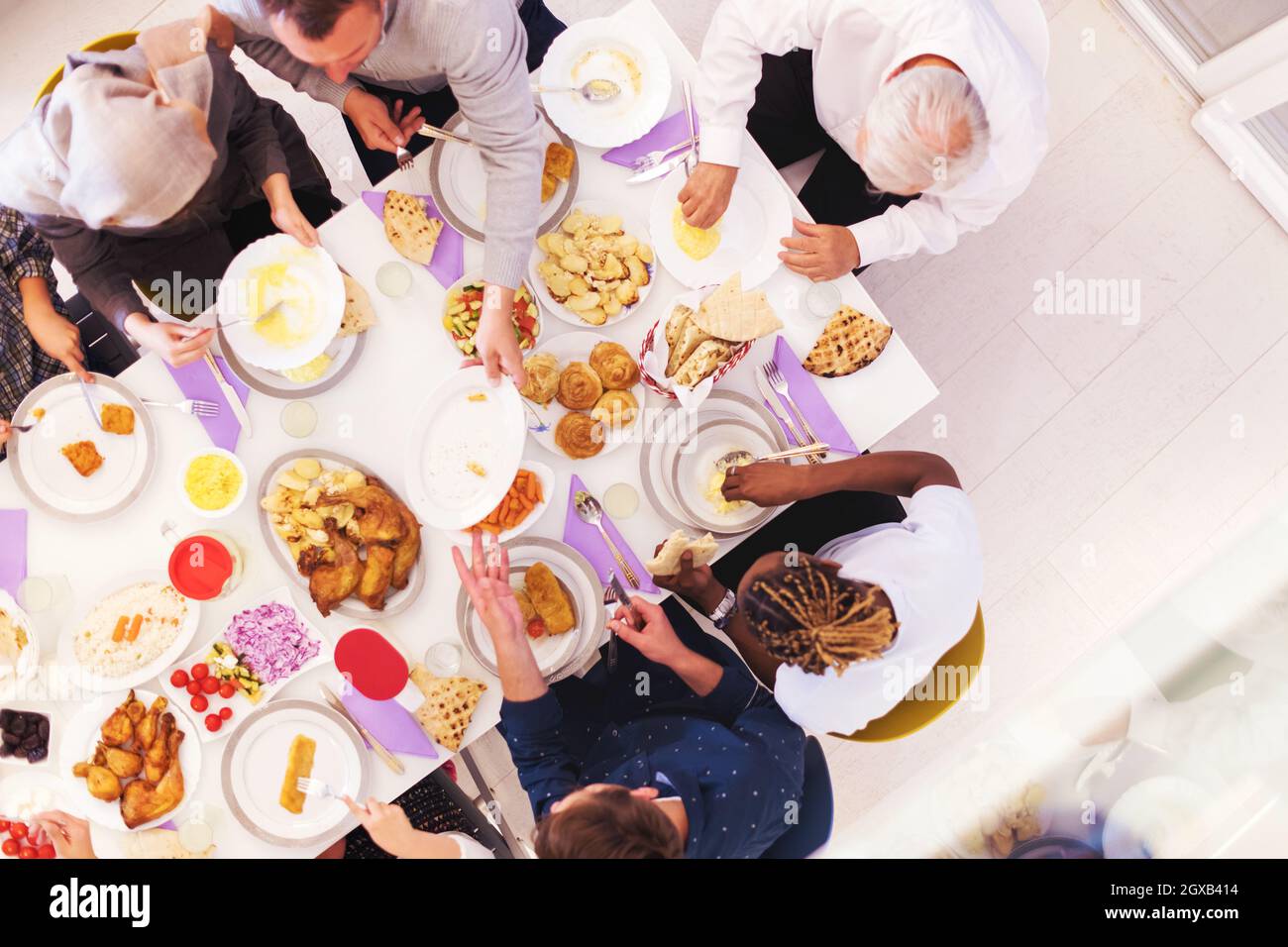 top view of modern multiethnic muslim family enjoying eating iftar ...