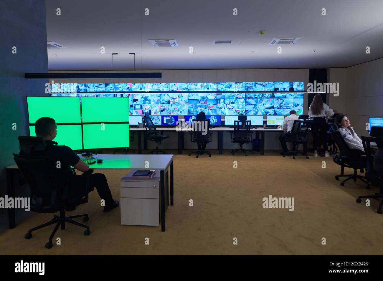 Group of Security data center operators working in a CCTV monitoring ...