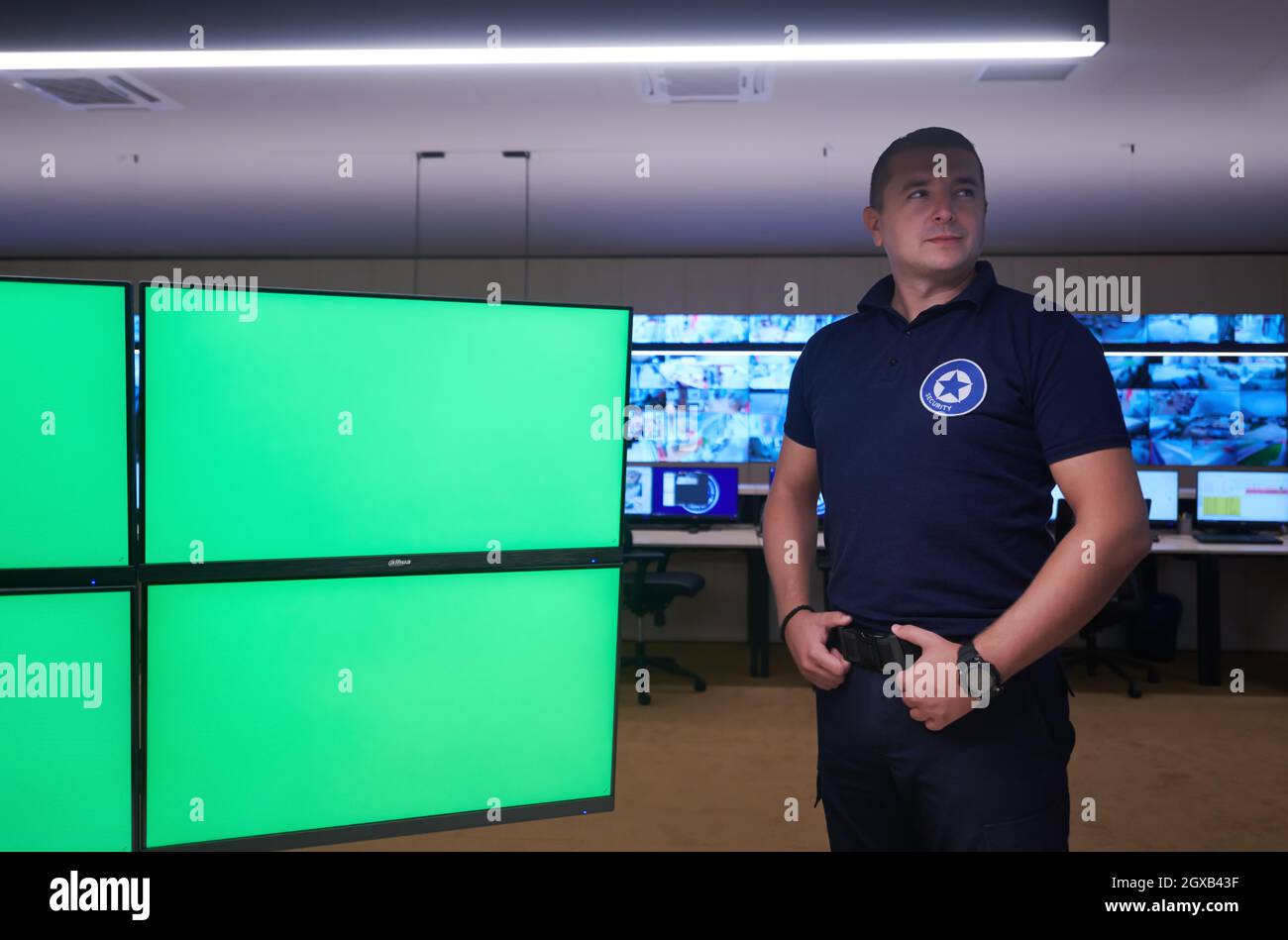 portrait of young male security operator working in a data system ...