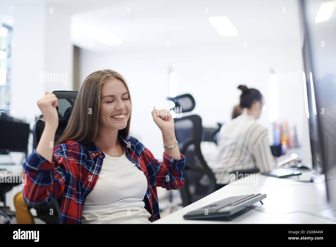 happy casual business woman celebrating success while working on ...