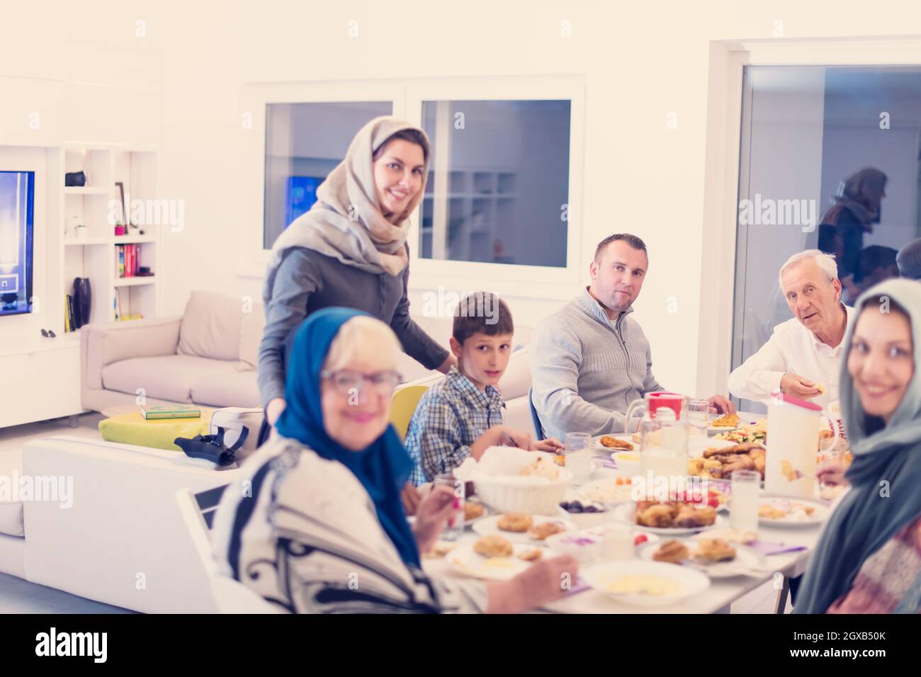 modern multiethnic muslim family enjoying eating iftar dinner together ...