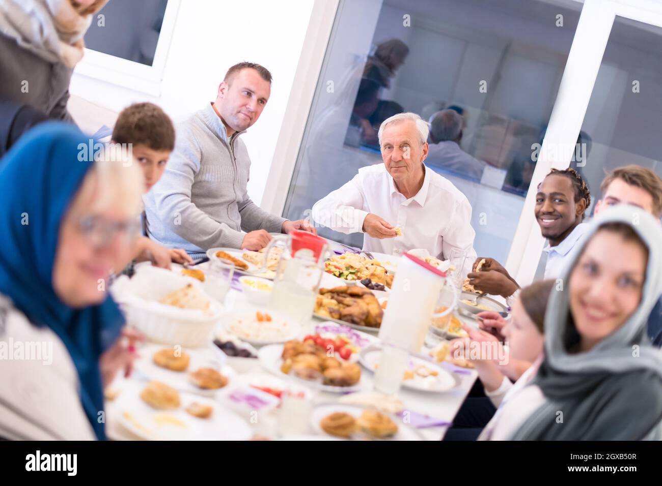 modern multiethnic muslim family enjoying eating iftar dinner together ...