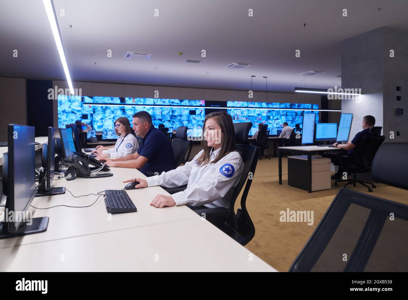 Group of Security data center operators working in a CCTV monitoring ...