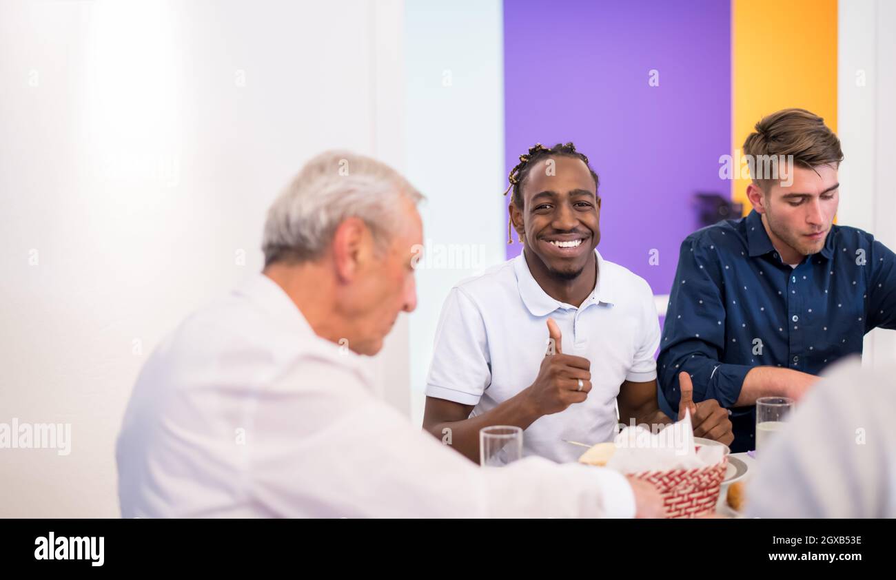 african american man enjoying iftar dinner together with modern ...