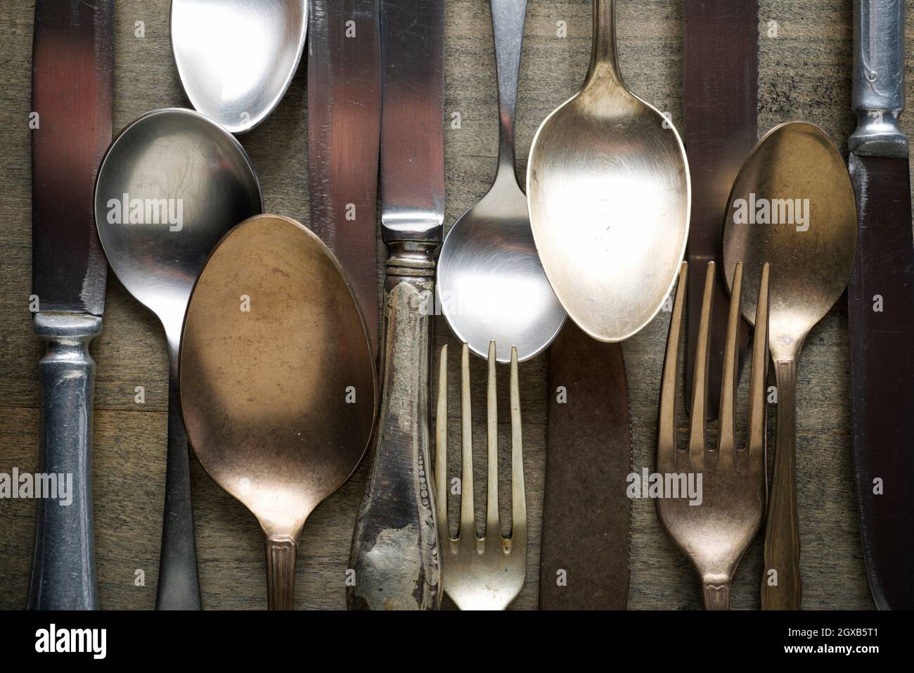 Kitchen cutlery collection on a wood table Stock Photo - Alamy