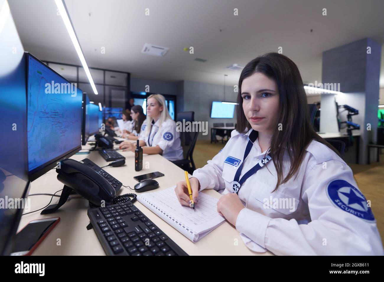 group of female security operators working in a data system control ...