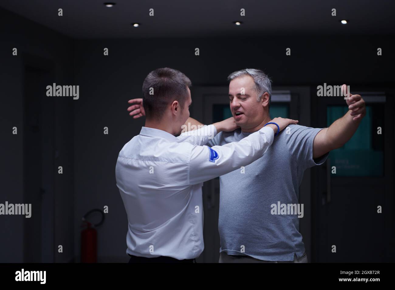 Security guard making body searching procedure on man for finding ...