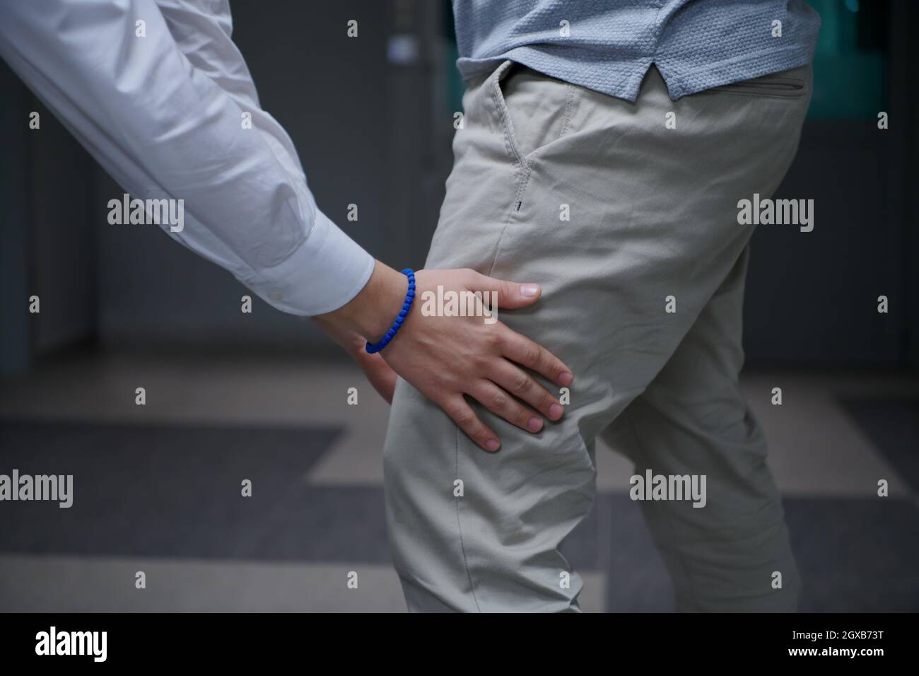 Security guard making body searching procedure on man for finding ...