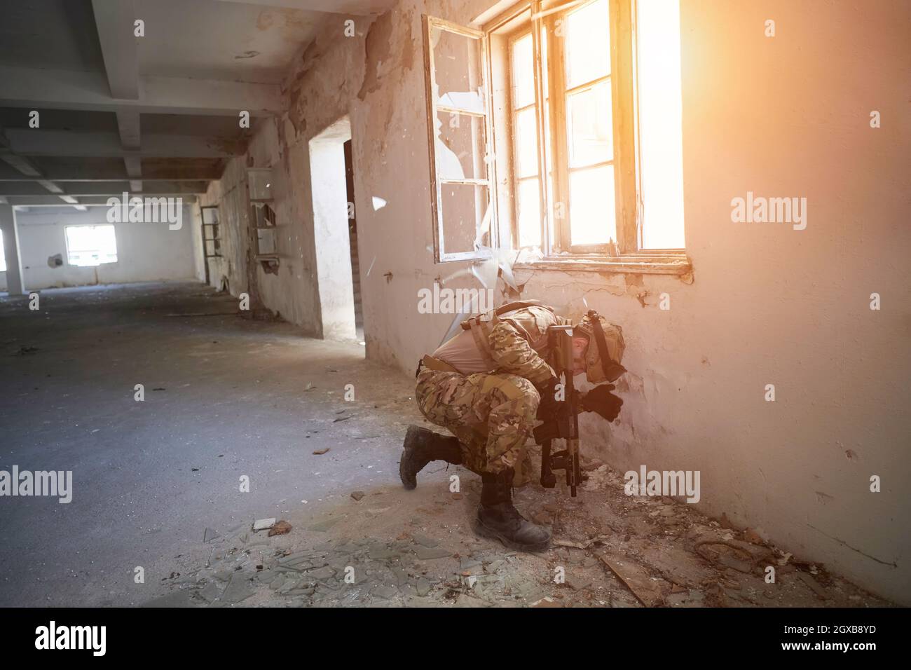 modern warfare soldier in action near window changing magazine and take ...