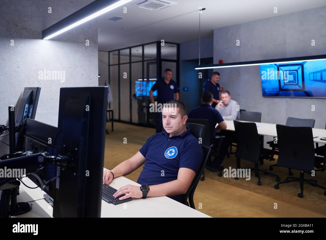 Group of Security data center operators working in a CCTV monitoring ...