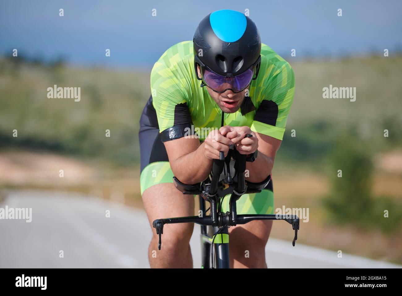 triathlon athlete riding professional racing bike at workout on curvy country road Stock Photo ...