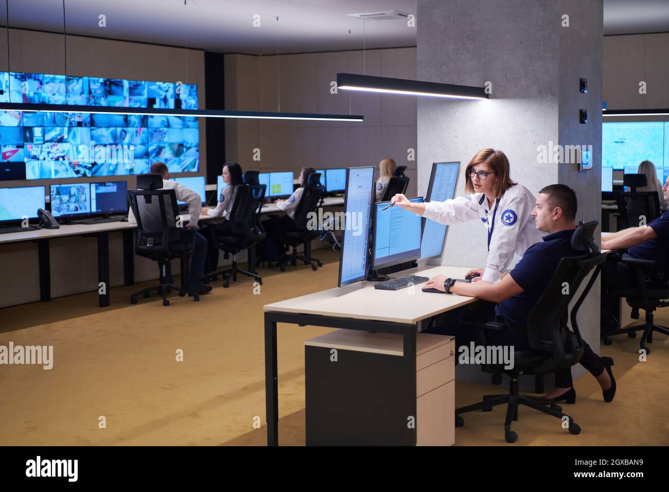 Group of Security data center operators working in a CCTV monitoring ...