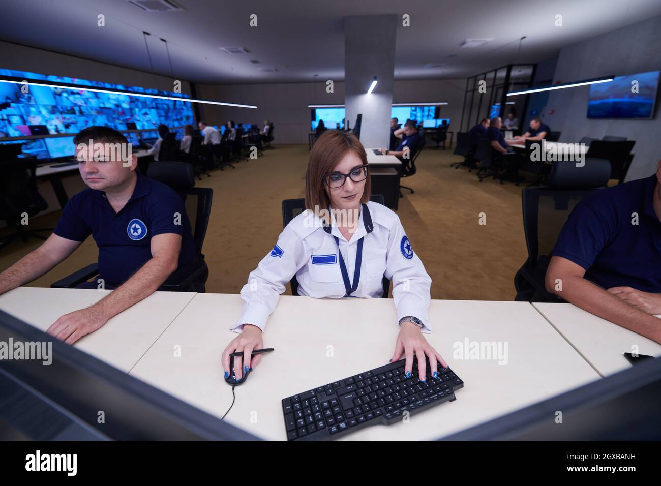 Female security operator working in a data system control room offices ...